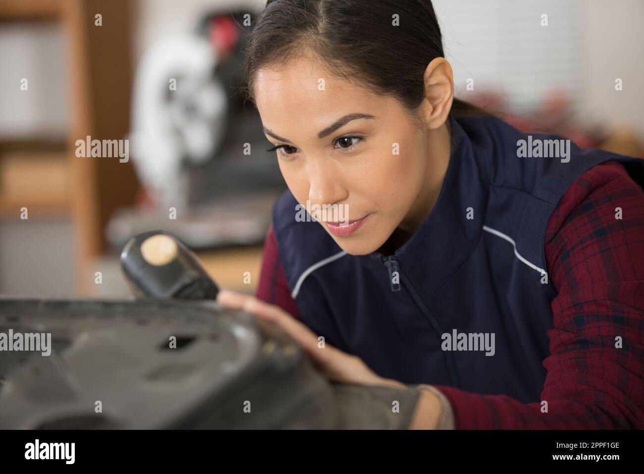 woman working with hammer in industrial building Stock Photo - Alamy