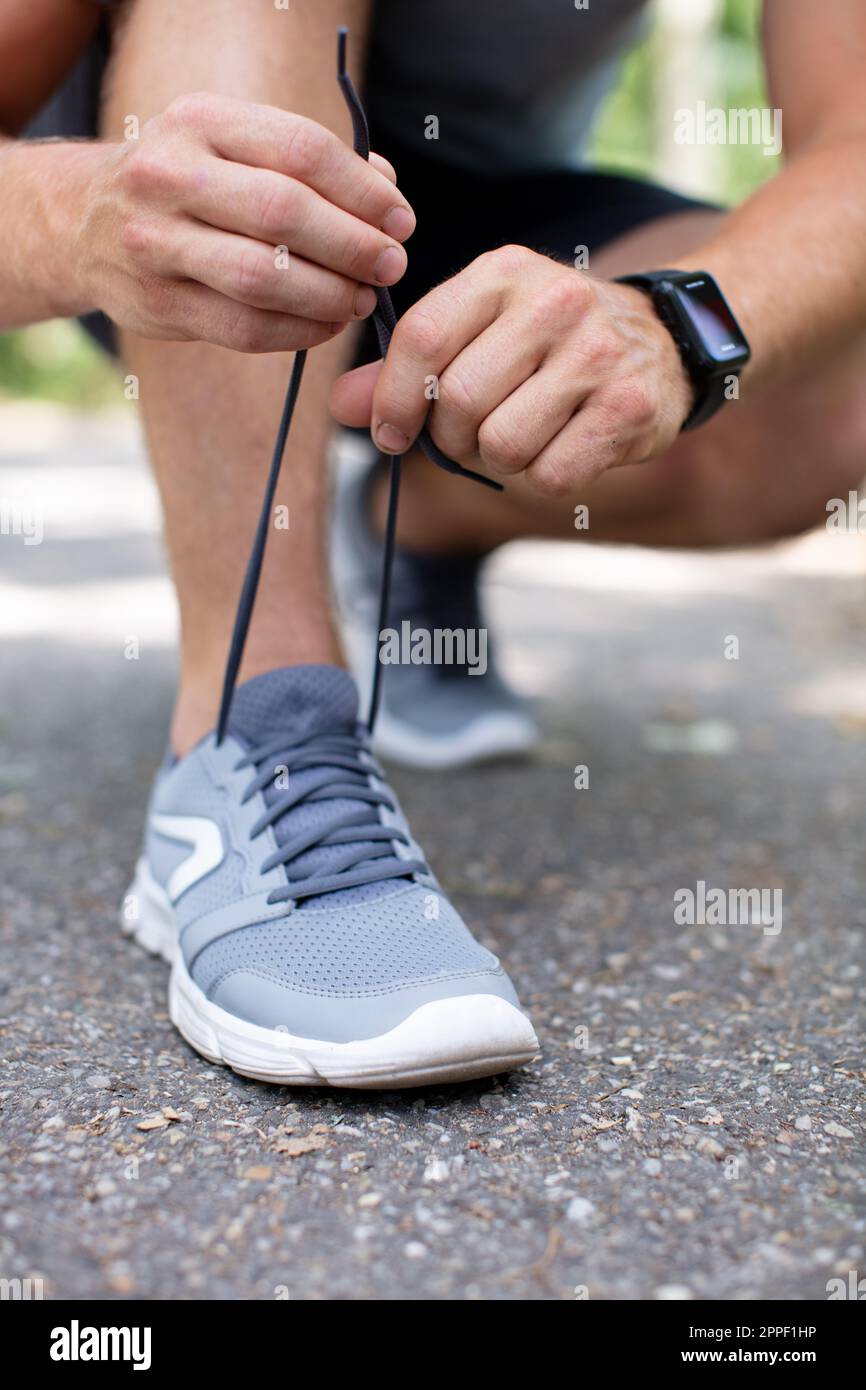 loseup of hands tying shoe laces Stock Photo - Alamy