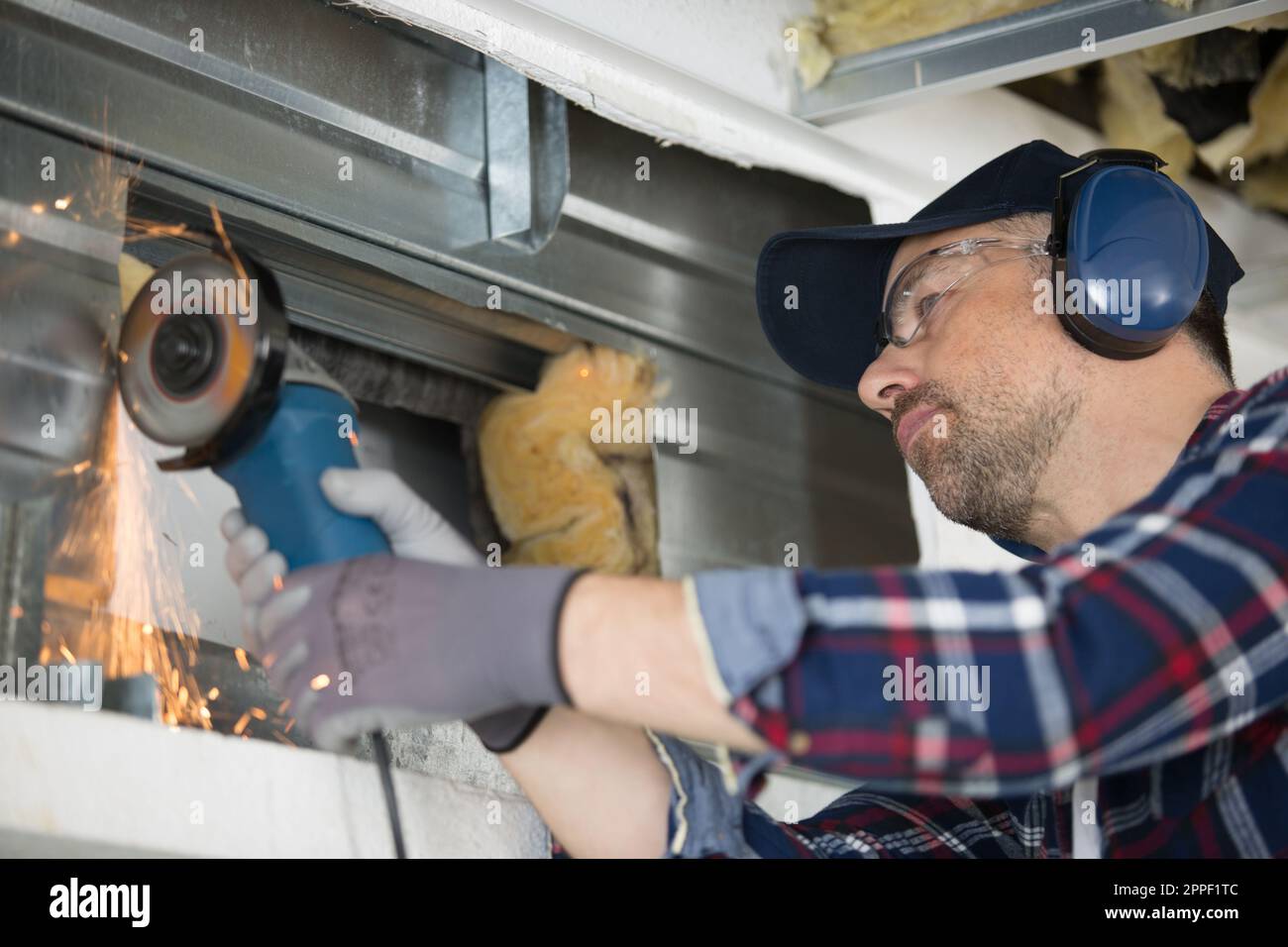 a worker cutting pvc profile Stock Photo - Alamy
