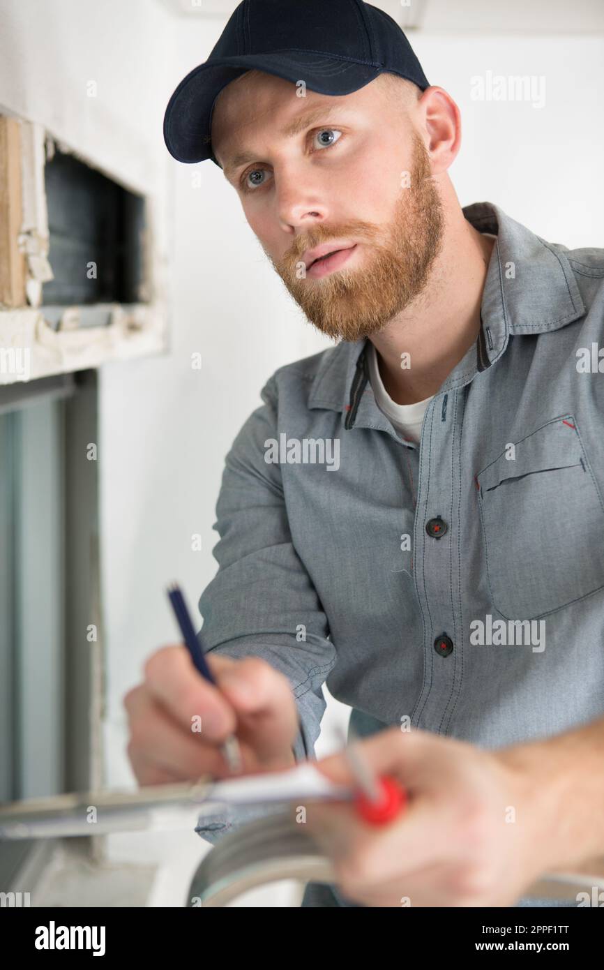 the man makes notes in the construction plan Stock Photo - Alamy
