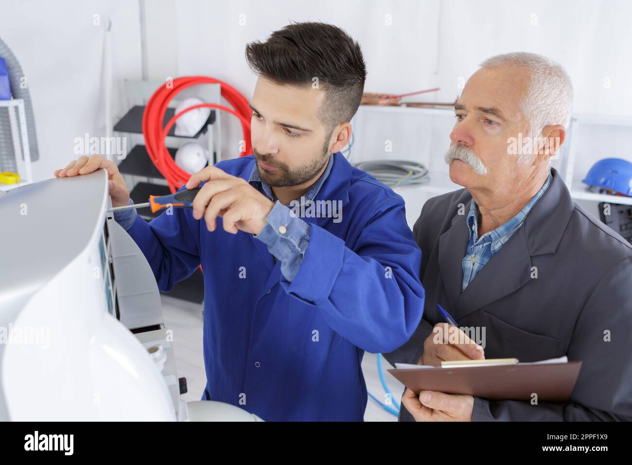 training male apprentice with teacher Stock Photo - Alamy