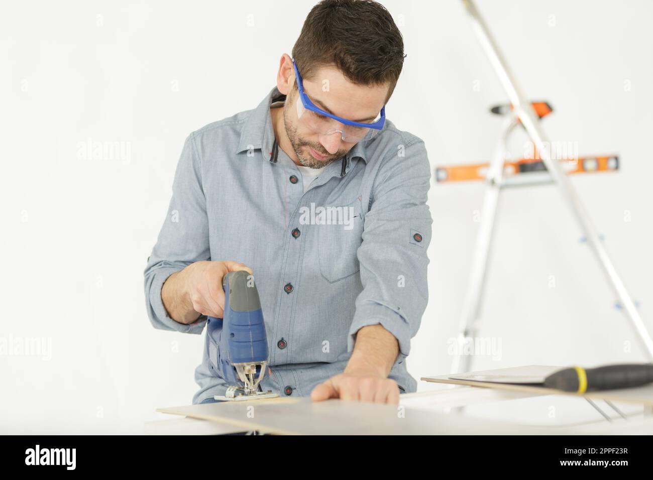 a man is wood sawing Stock Photo - Alamy