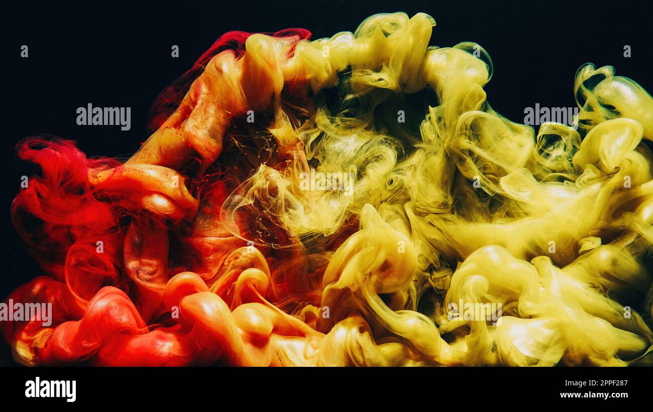 Ink drop paint water fluid explosion yellow red Stock Photo - Alamy