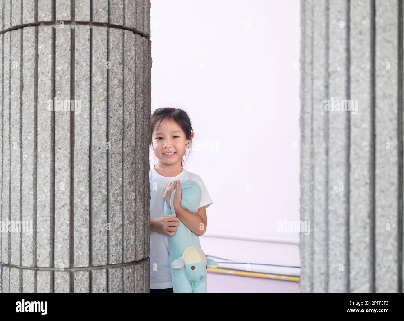Adorable little girl playing peekaboo, asian child Stock Photo - Alamy