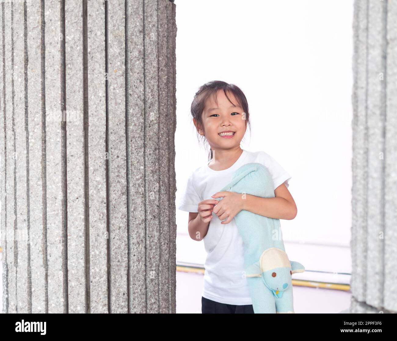 Adorable little girl playing peekaboo, asian child Stock Photo - Alamy