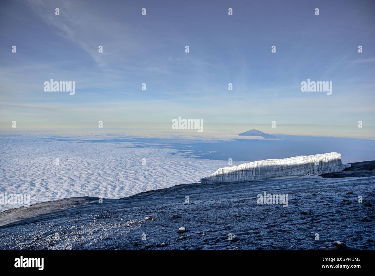 An expansive view of a snow-covered mountain, with a partially frozen ...