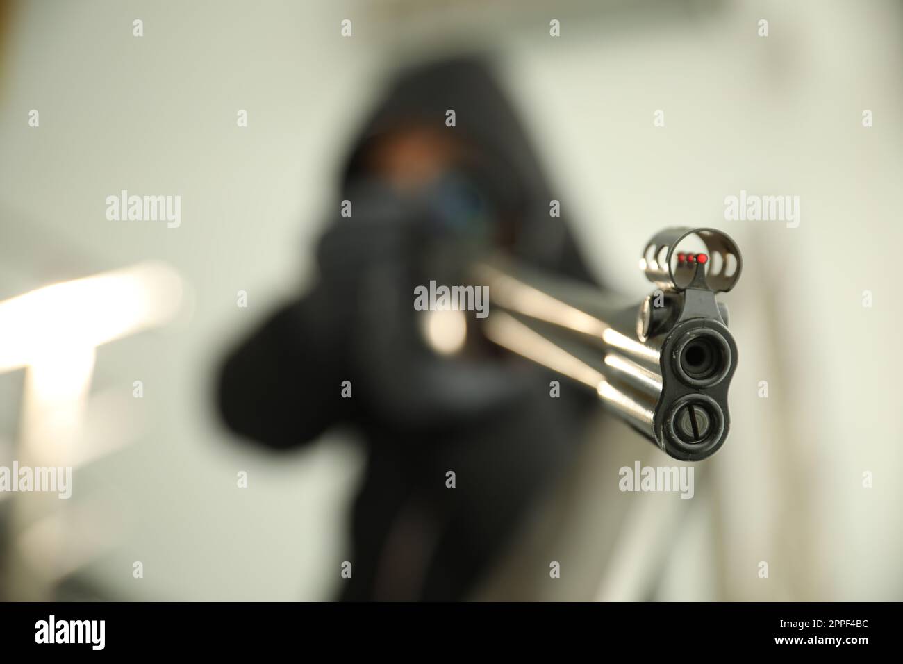 Hired professional killer indoors, focus on sniper rifle Stock Photo ...