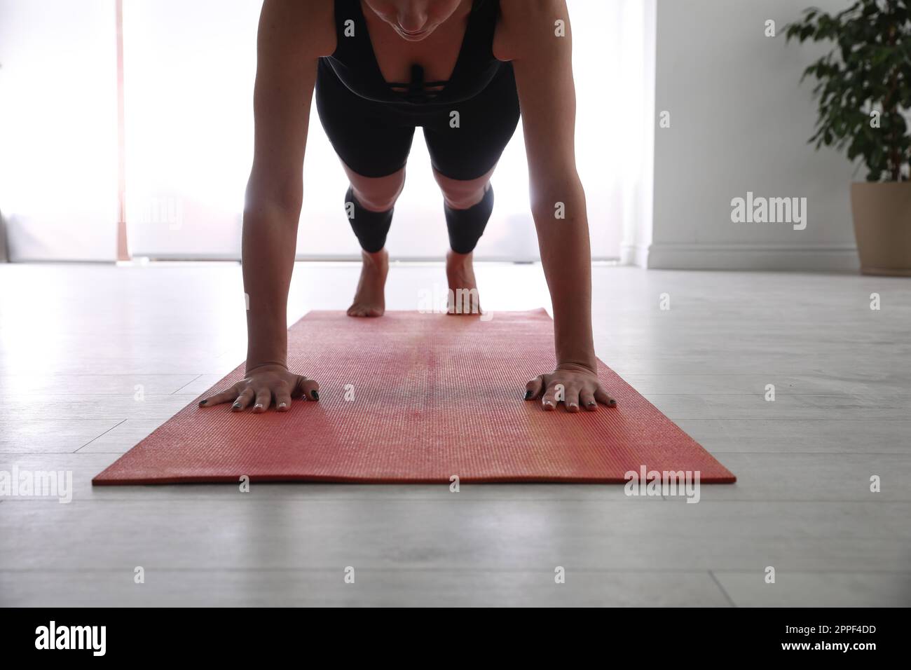 Woman practicing plank asana in yoga studio, closeup. Phalankasana pose ...