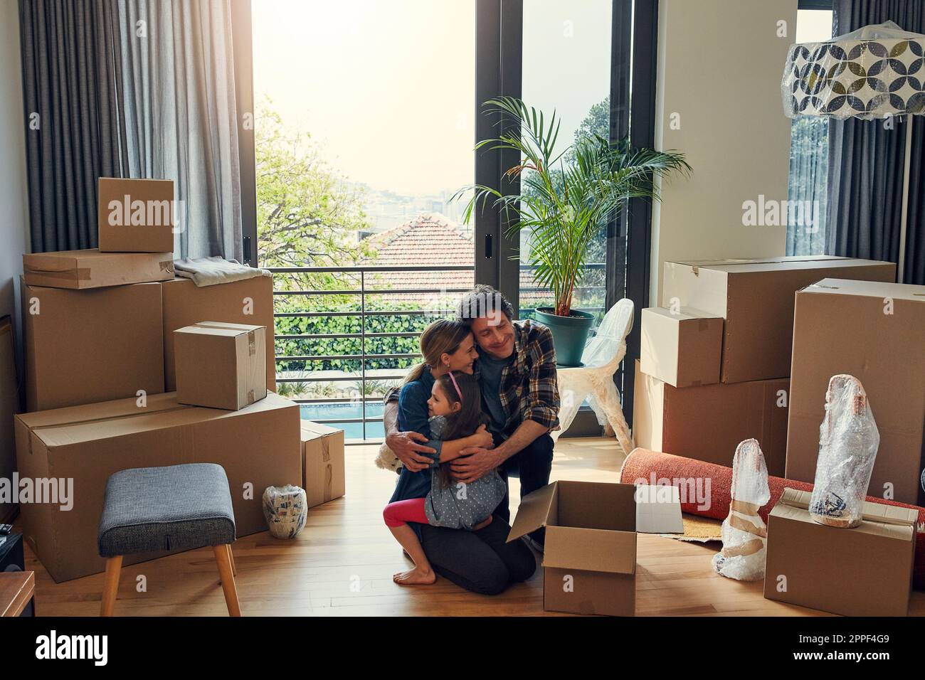 One happy family. a cheerful loving family packing out boxes together ...