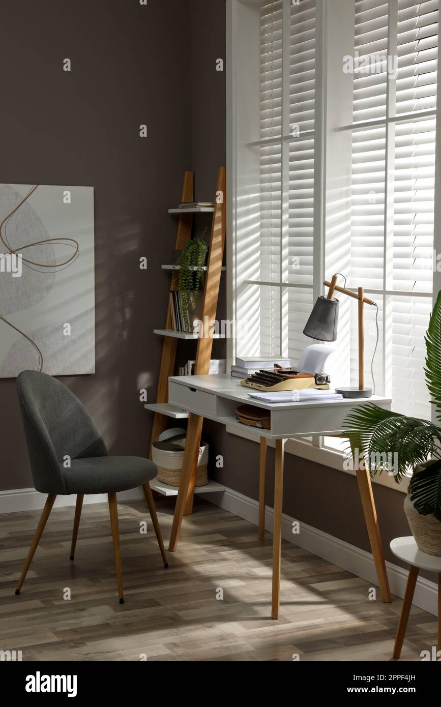 Comfortable writer's workplace interior with typewriter on desk in ...