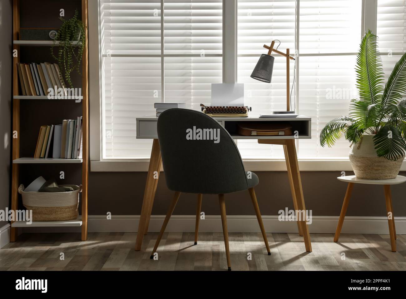 Comfortable writer's workplace interior with typewriter on desk in ...