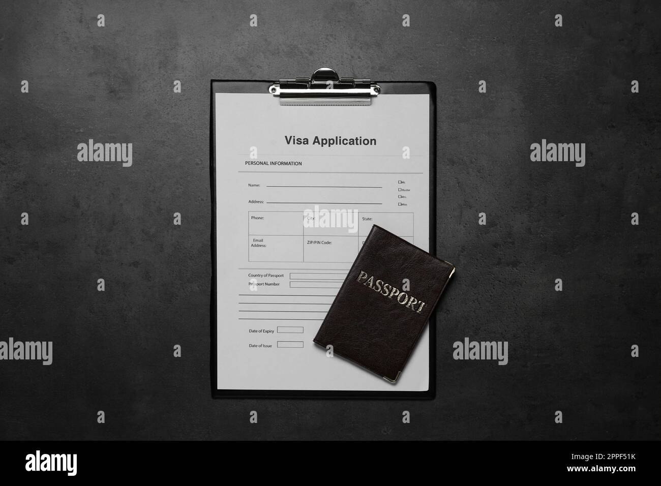 Visa application form for immigration and passport on grey table, top ...