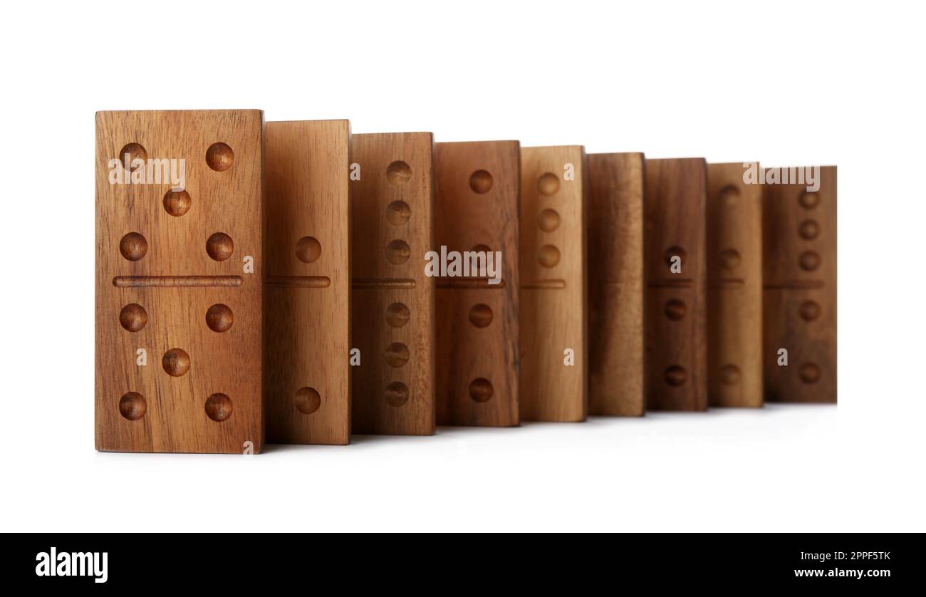 Row of wooden domino tiles on white background Stock Photo - Alamy