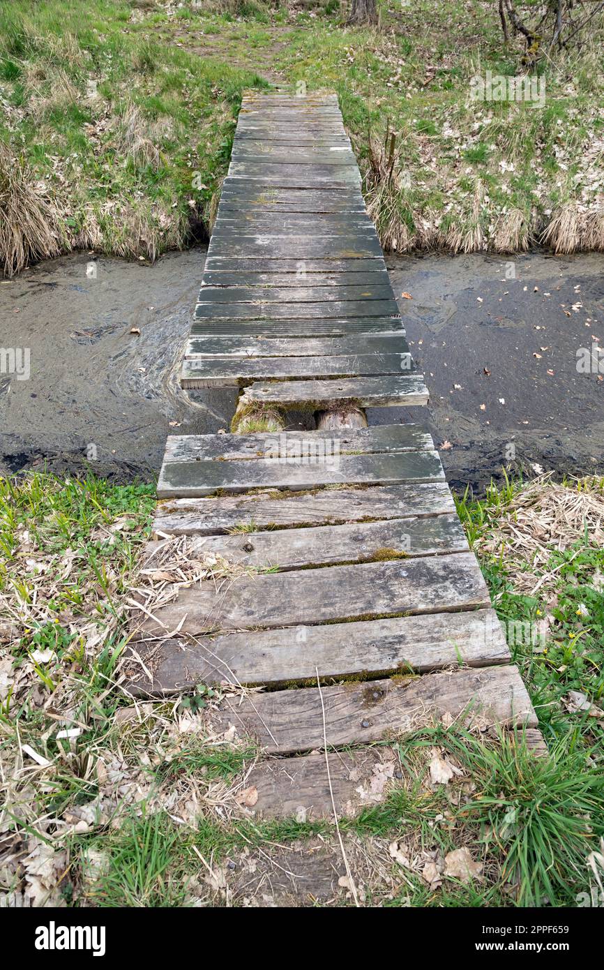 scruffy wooden footbridge over drainage ditch Stock Photo - Alamy
