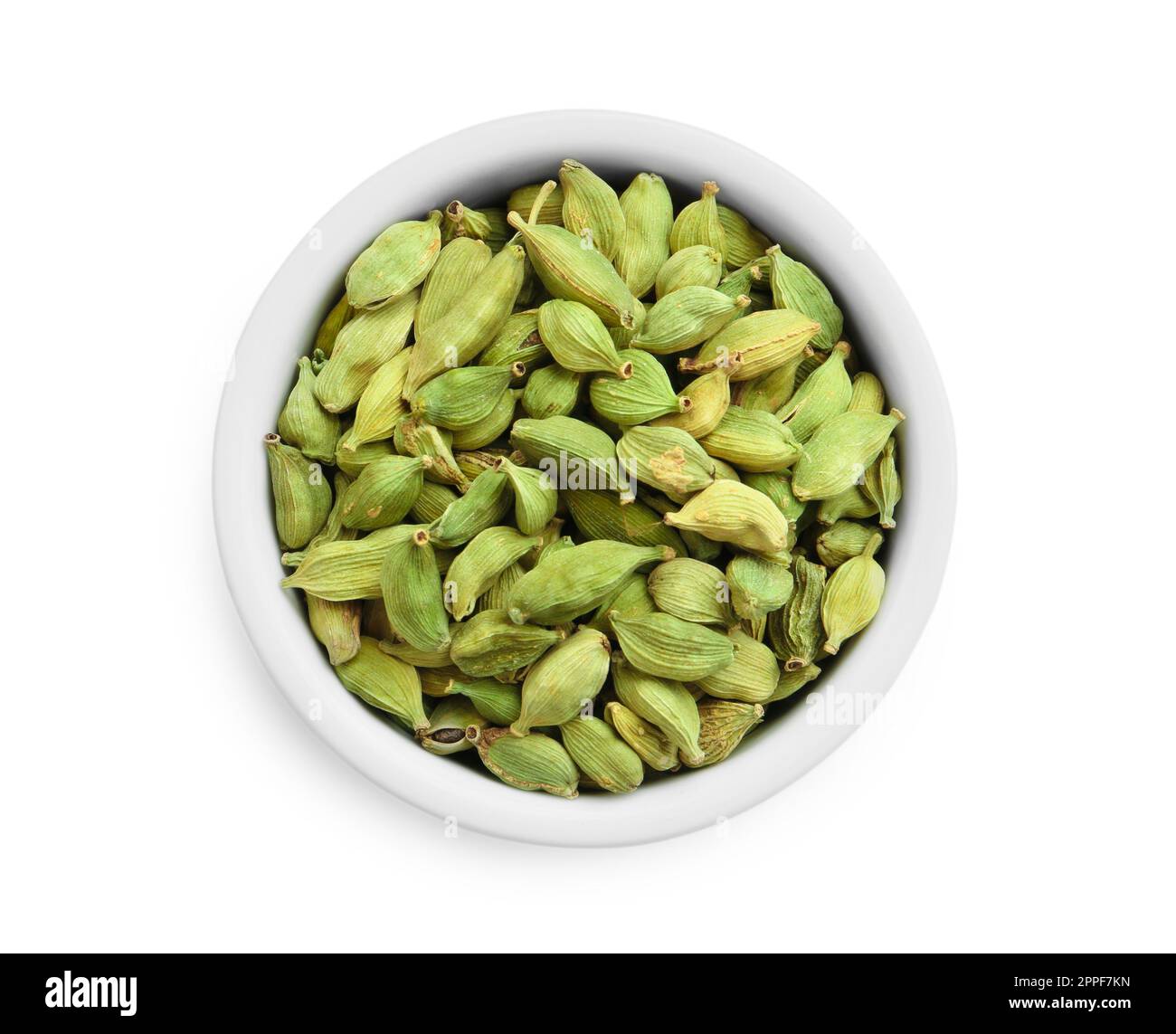 Dry cardamom pods in bowl isolated on white, top view Stock Photo - Alamy