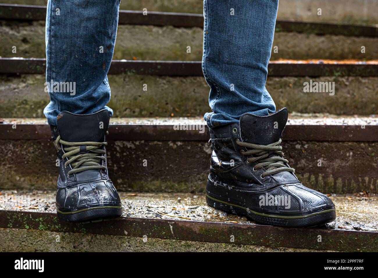 A man in boots on the old steps, close-up Stock Photo - Alamy