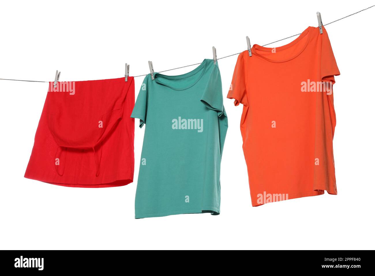 Different bright clothes drying on washing line against white ...