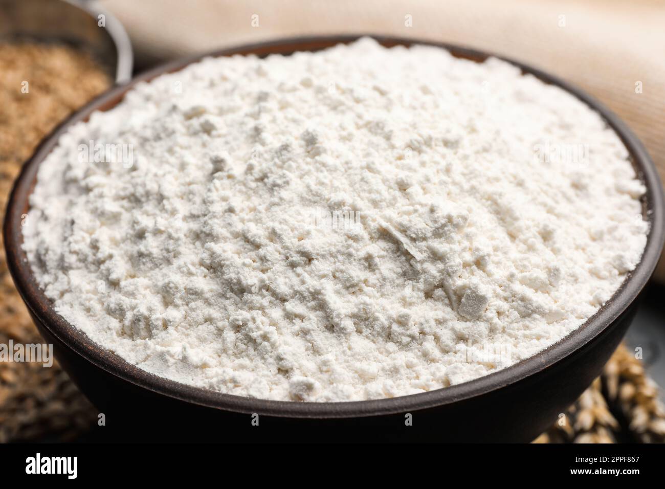 Organic wheat flour in bowl, closeup view Stock Photo - Alamy