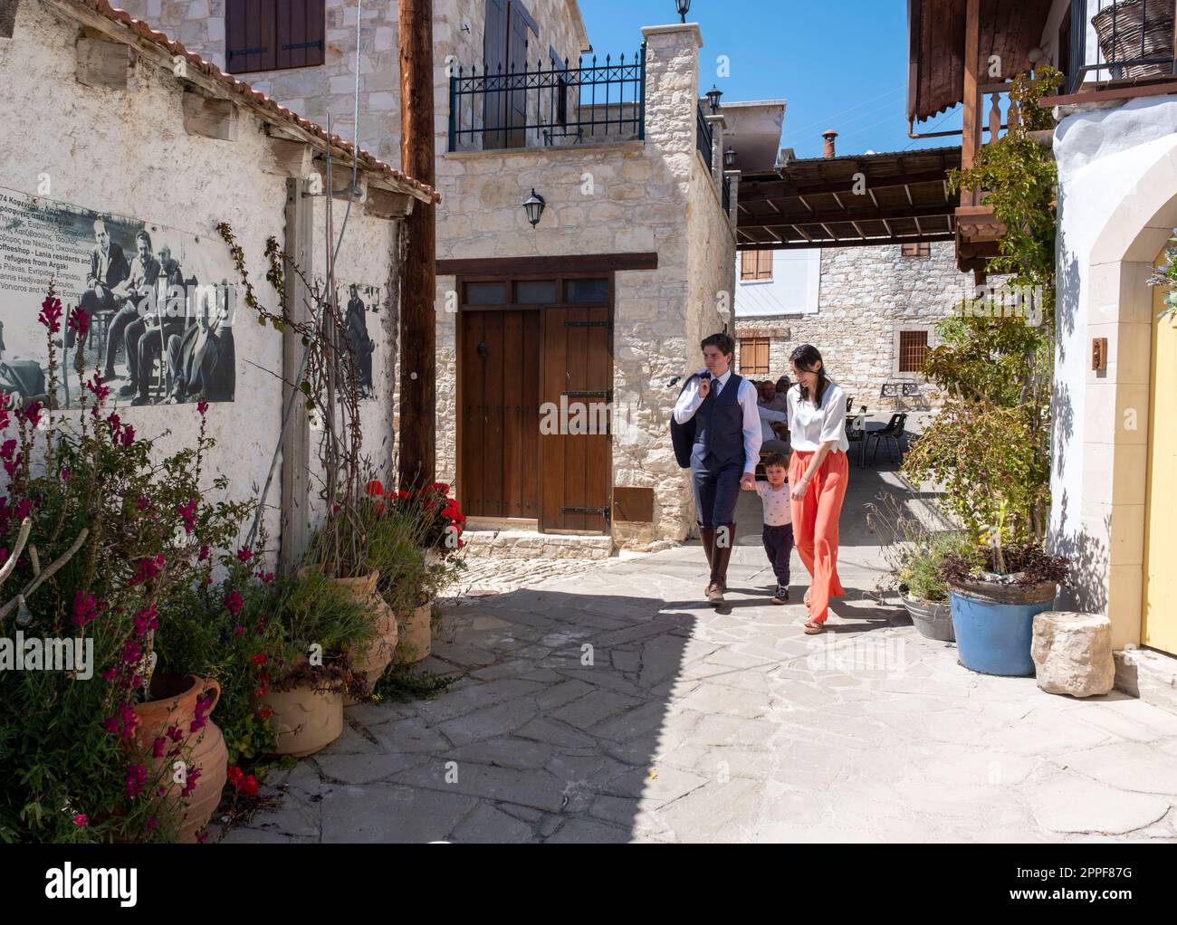A young couple and child walking in Lania village, Cyprus Stock Photo ...