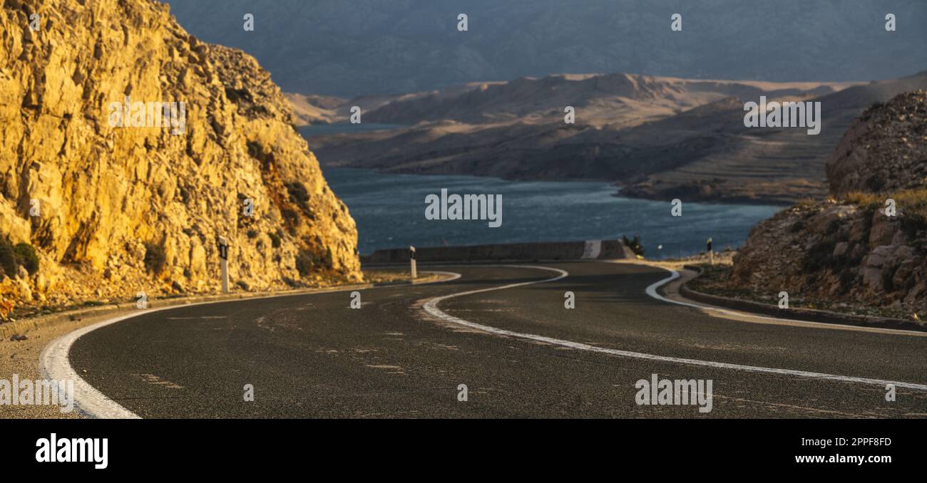 An asphalt road running past a beautiful viewpoint on the Island of Pag ...