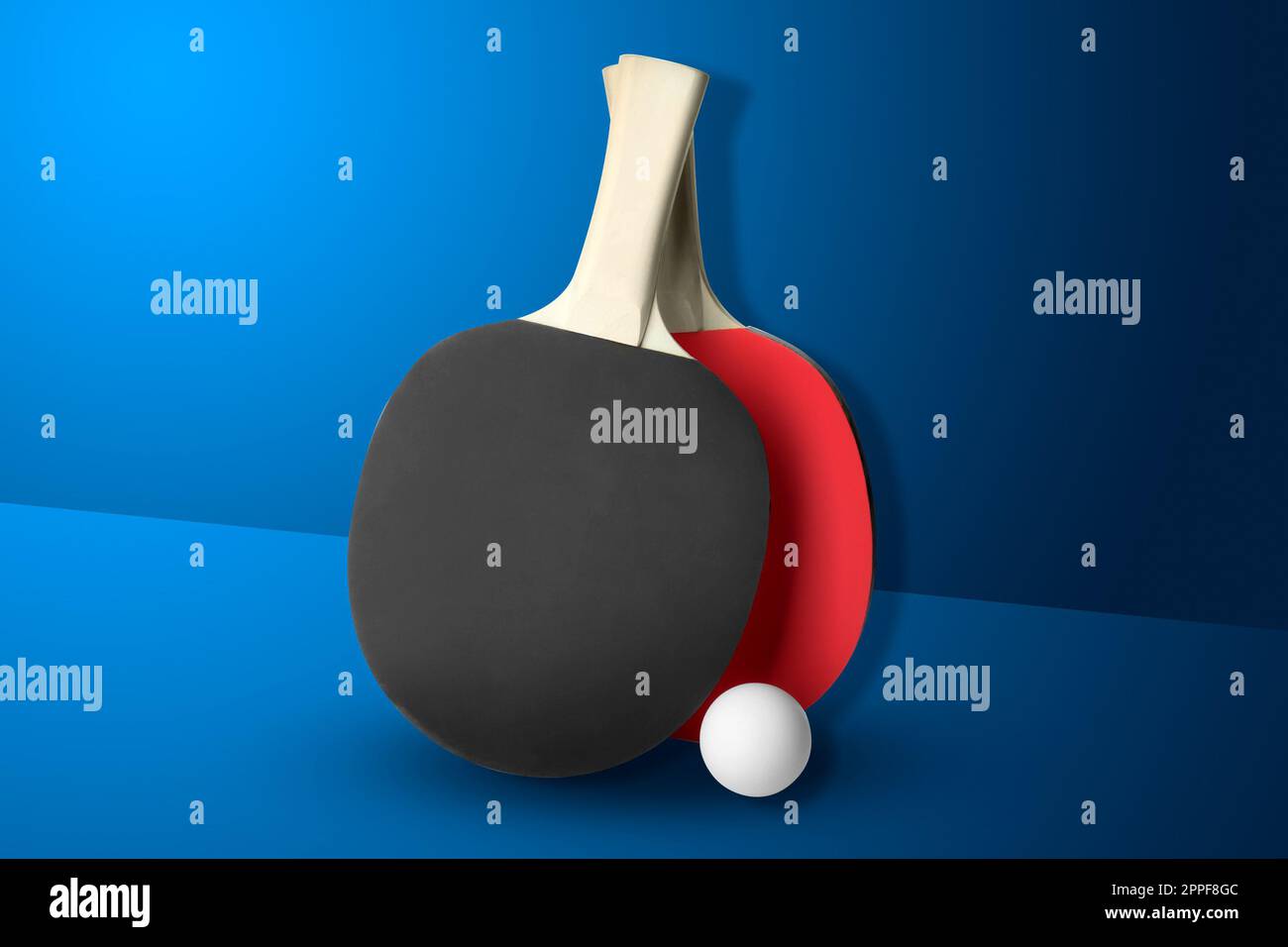 Ping pong paddles and ball on blue background. Table tennis ...