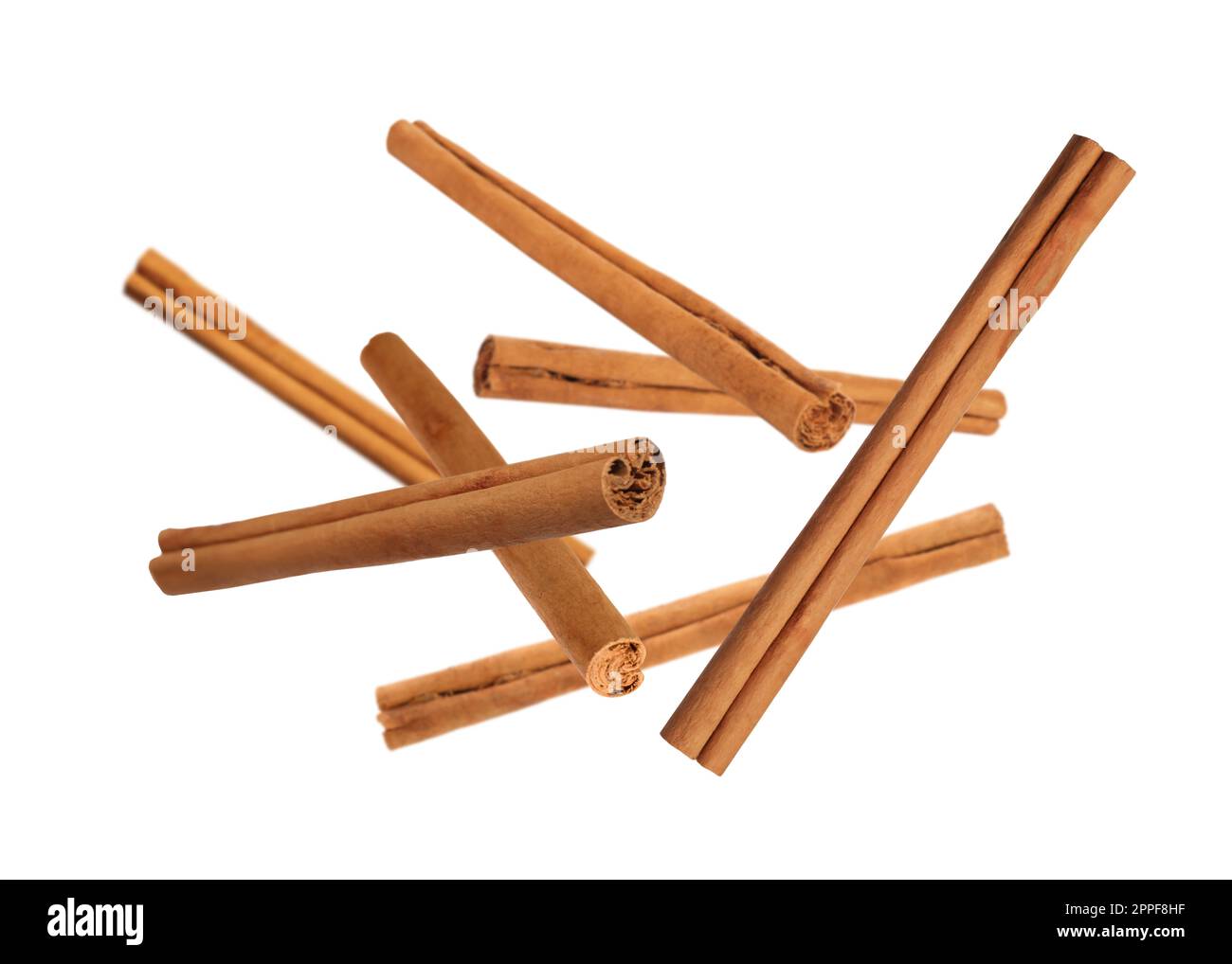 Aromatic dry cinnamon sticks falling on white background Stock Photo ...