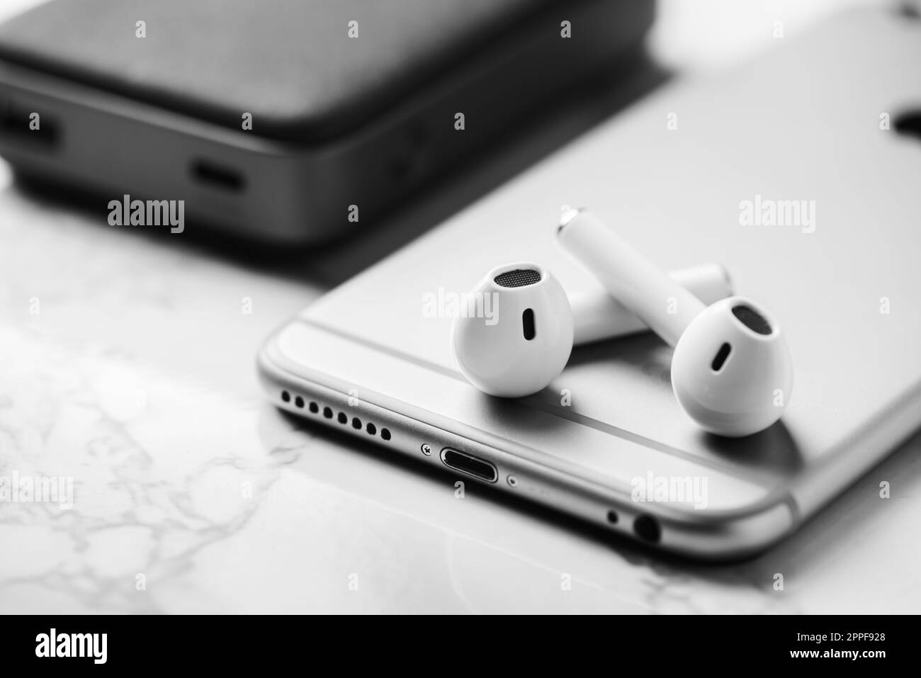 True wireless earbuds Black and White Stock Photos & Images - Alamy