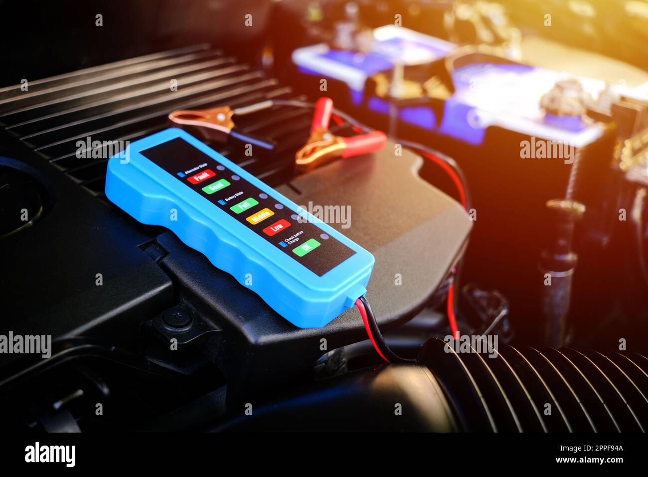 Checking a car battery level with car battery checker, car repairing ...