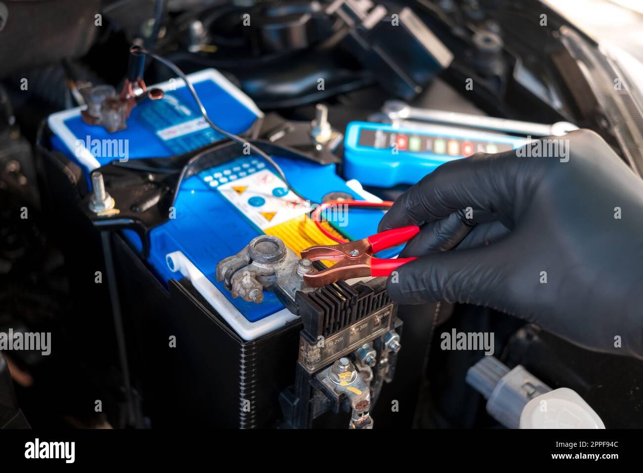 Checking a car battery level with car battery checker, car repairing ...