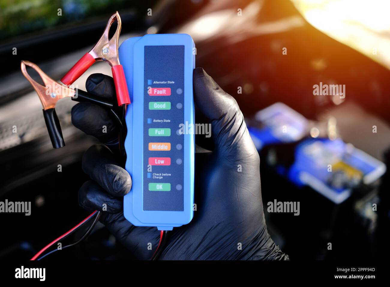 Checking a car battery level with car battery checker, car repairing ...