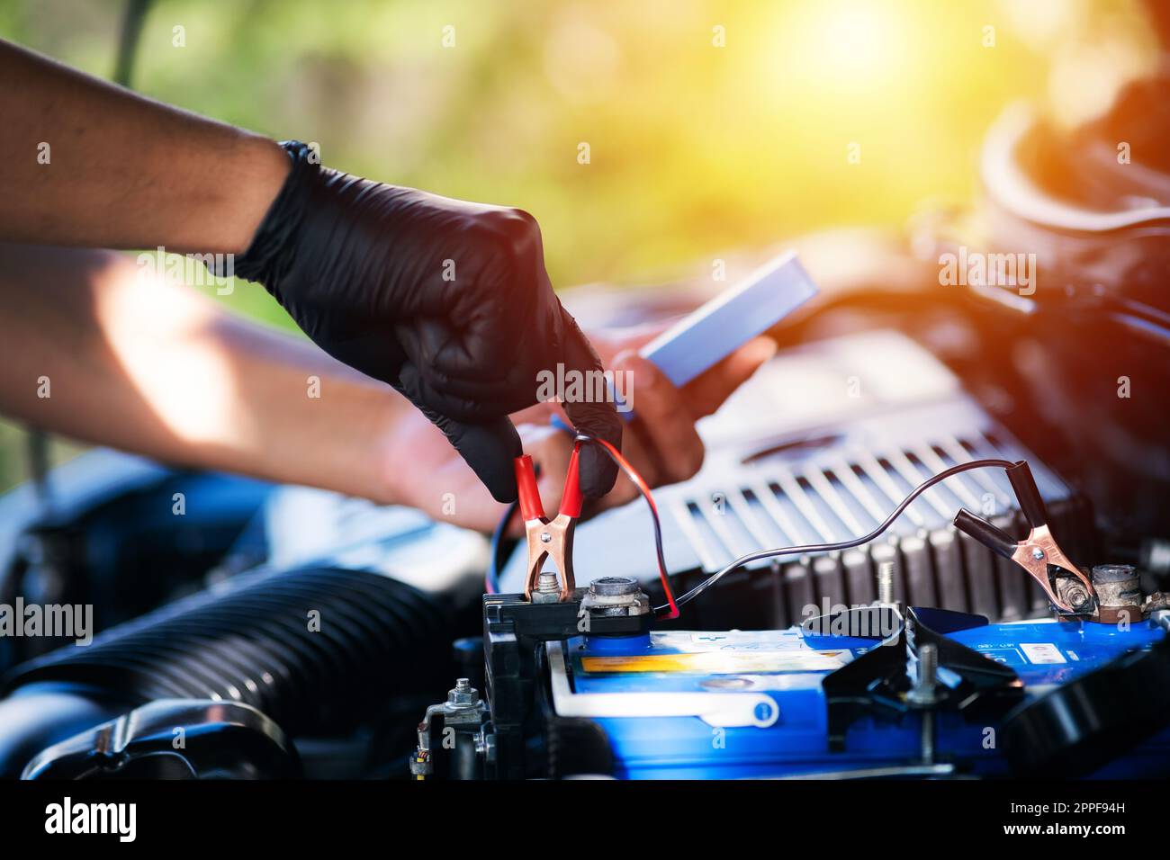 Checking a car battery level with car battery checker, car repairing ...