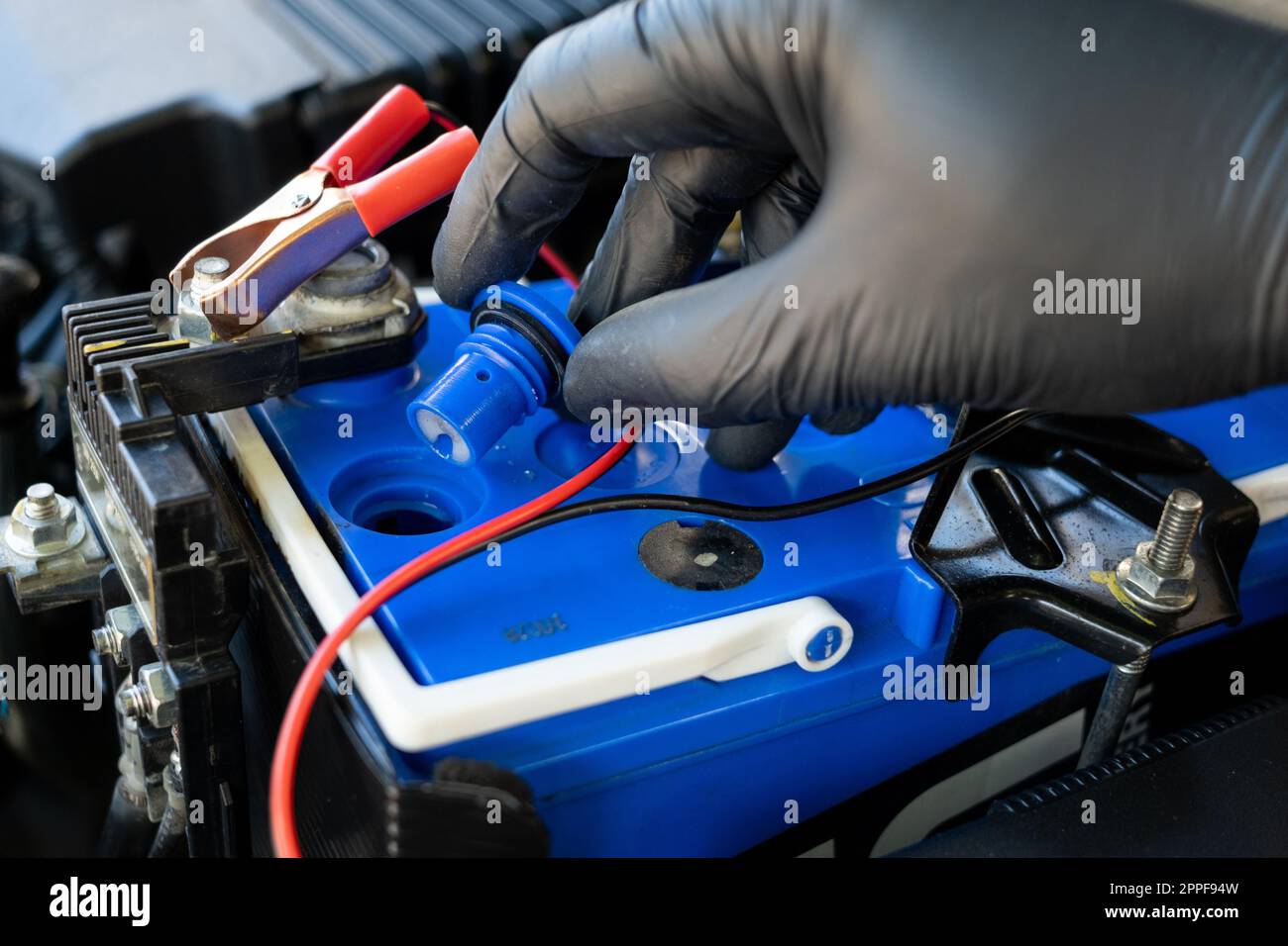 Checking a car battery level with car battery checker, car repairing ...