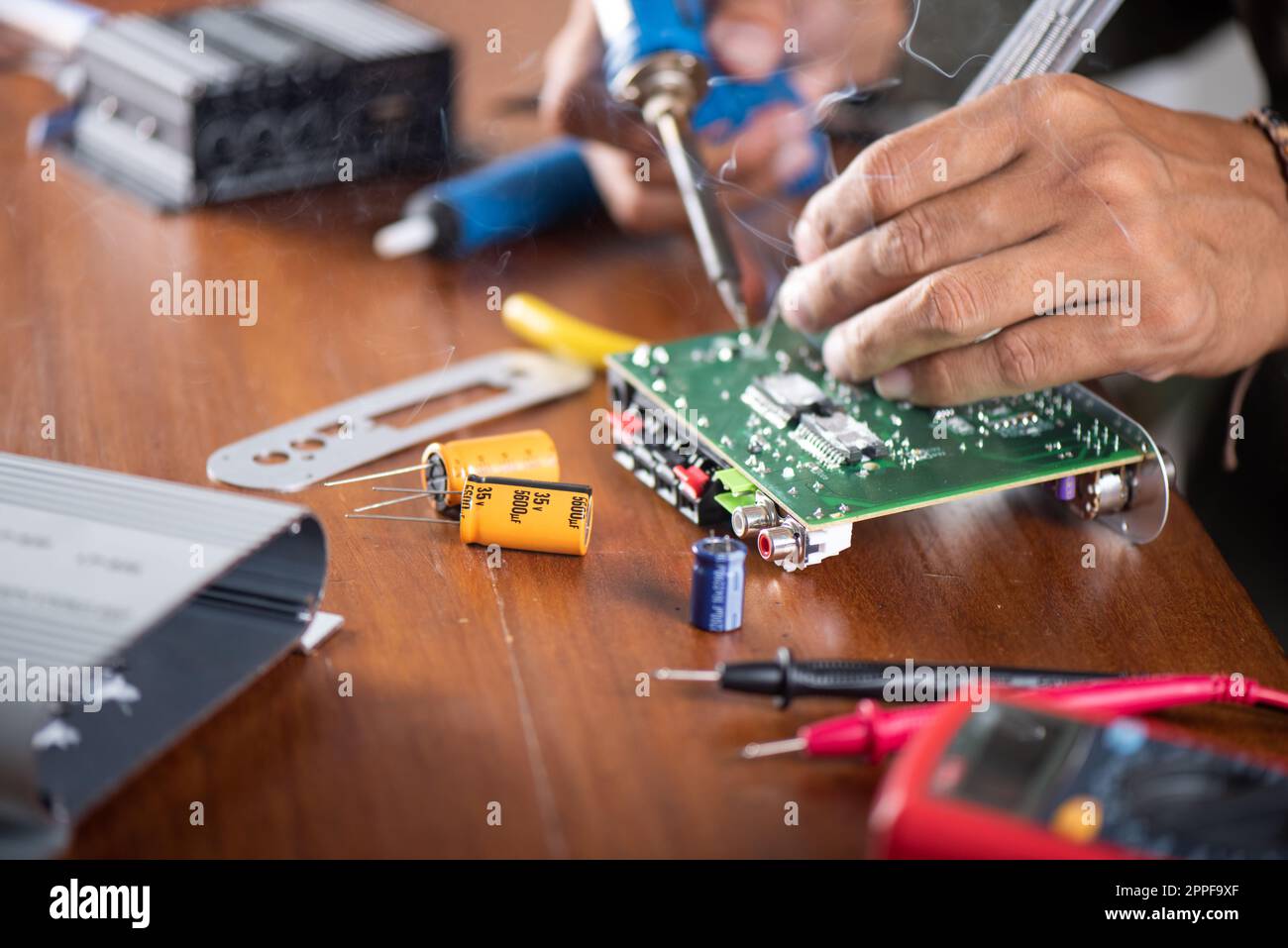 Technician repairing the electronic device. Reparing the audio ...