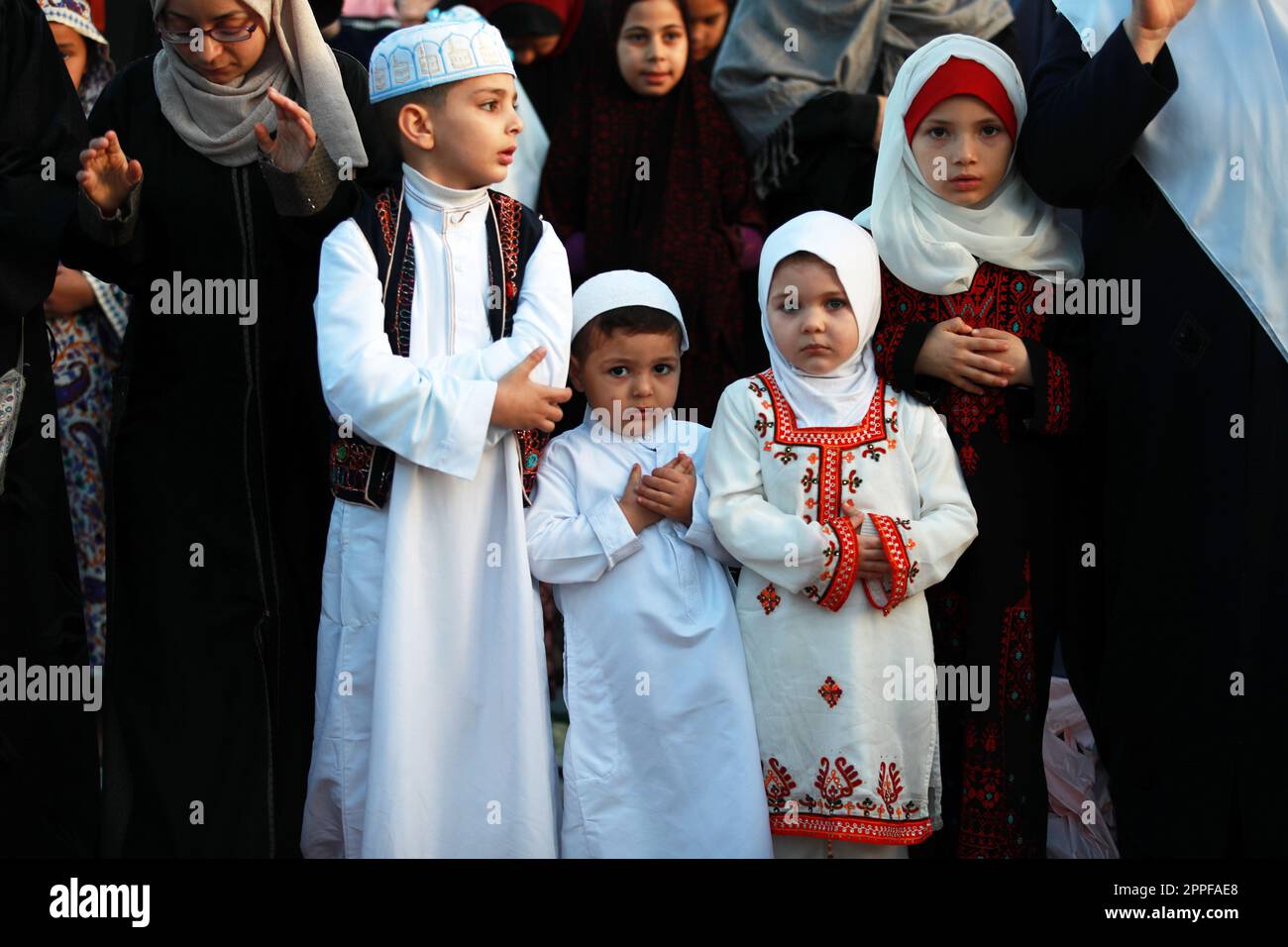 Palestinians perform Eid al-Fitr prayers. Eid al-Fitr, which marks the ...