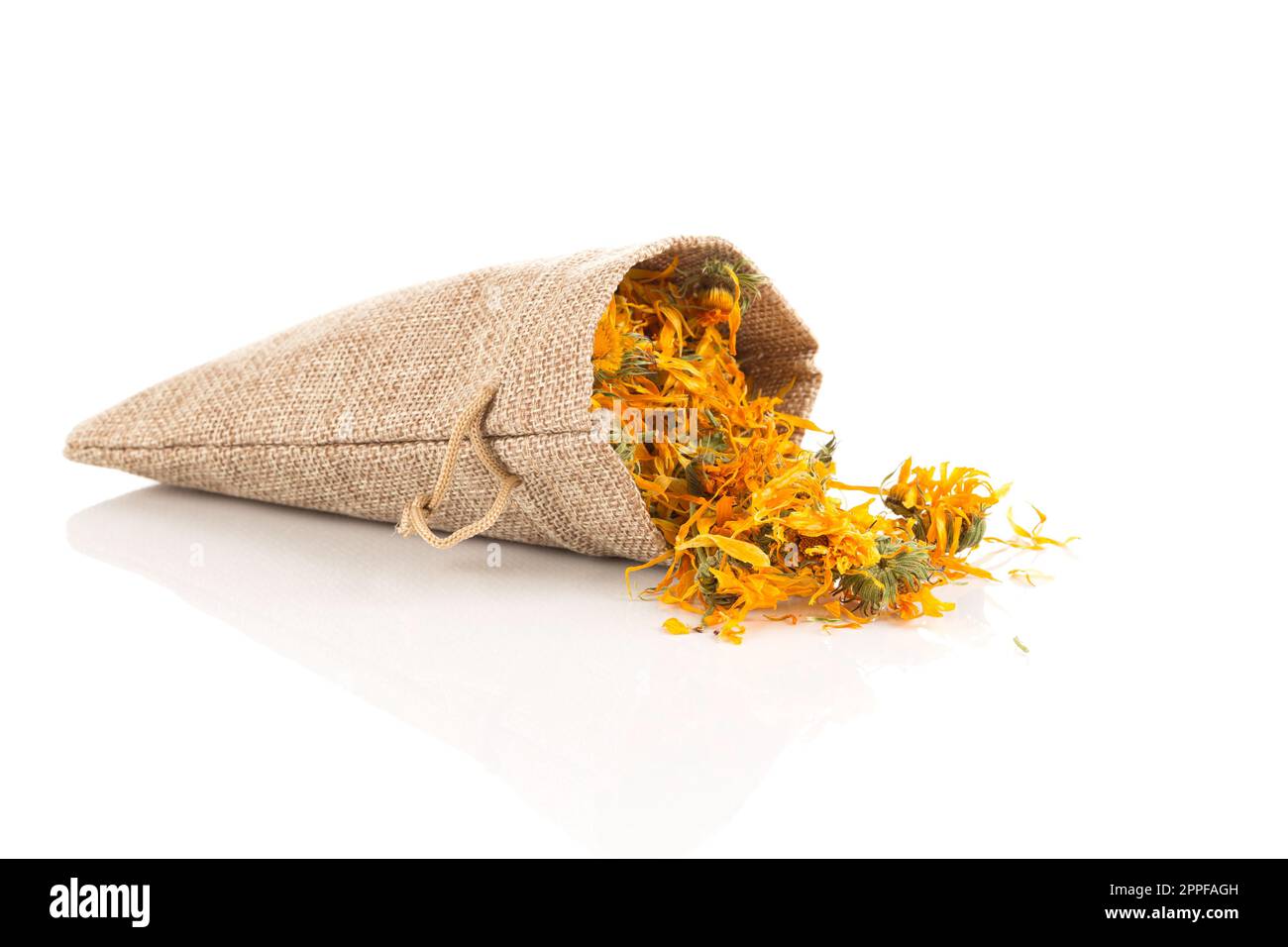 Calendula flowewr tea for infusion in sack on white background Stock ...