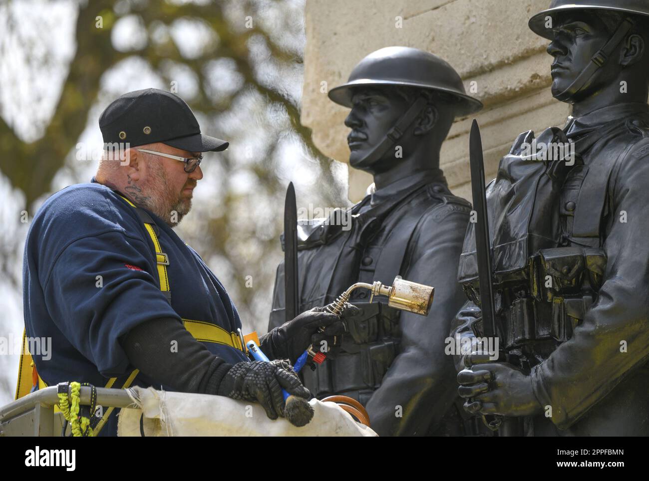 London, England, UK. Man carrying out cleaning / restoration of Guards ...