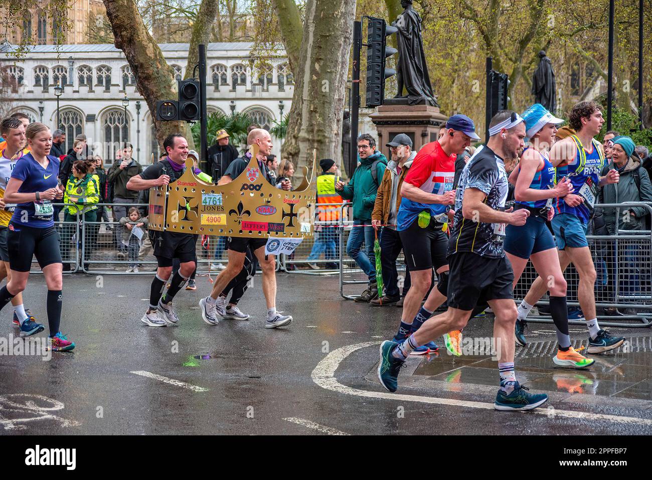 London, UK. 23rd Apr, 2023. Three men are running inside a crown during ...