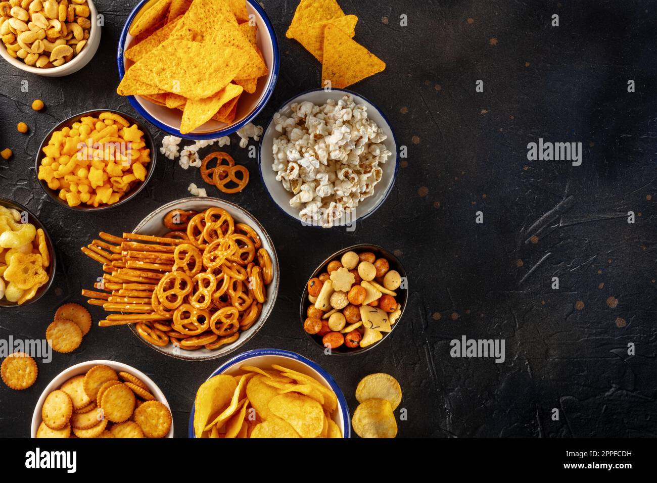 Salty snacks, party mix, overhead flat lay shot with copy space. An ...