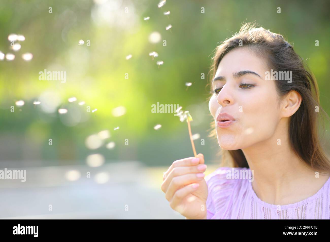 Girl blowing dandelion seed hi-res stock photography and images - Alamy