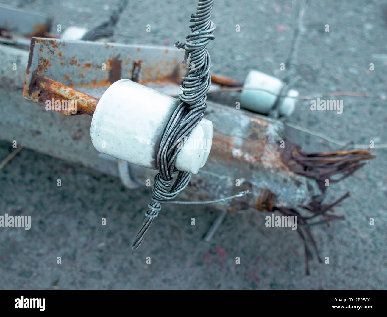 A traverse insulator on an old rusty electric power high voltage ...