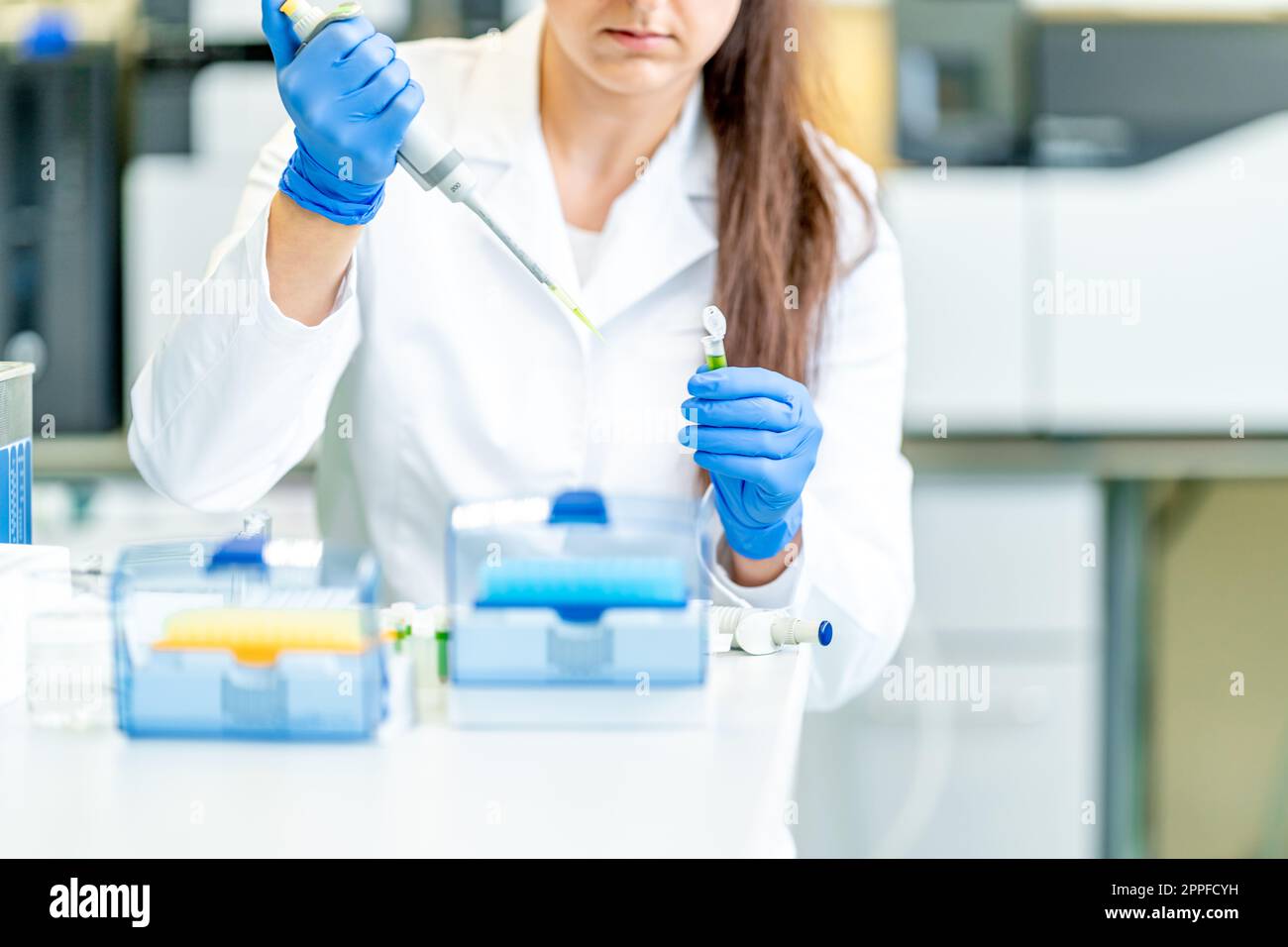 dropper dosing of chemical samples into flasks for research in a ...