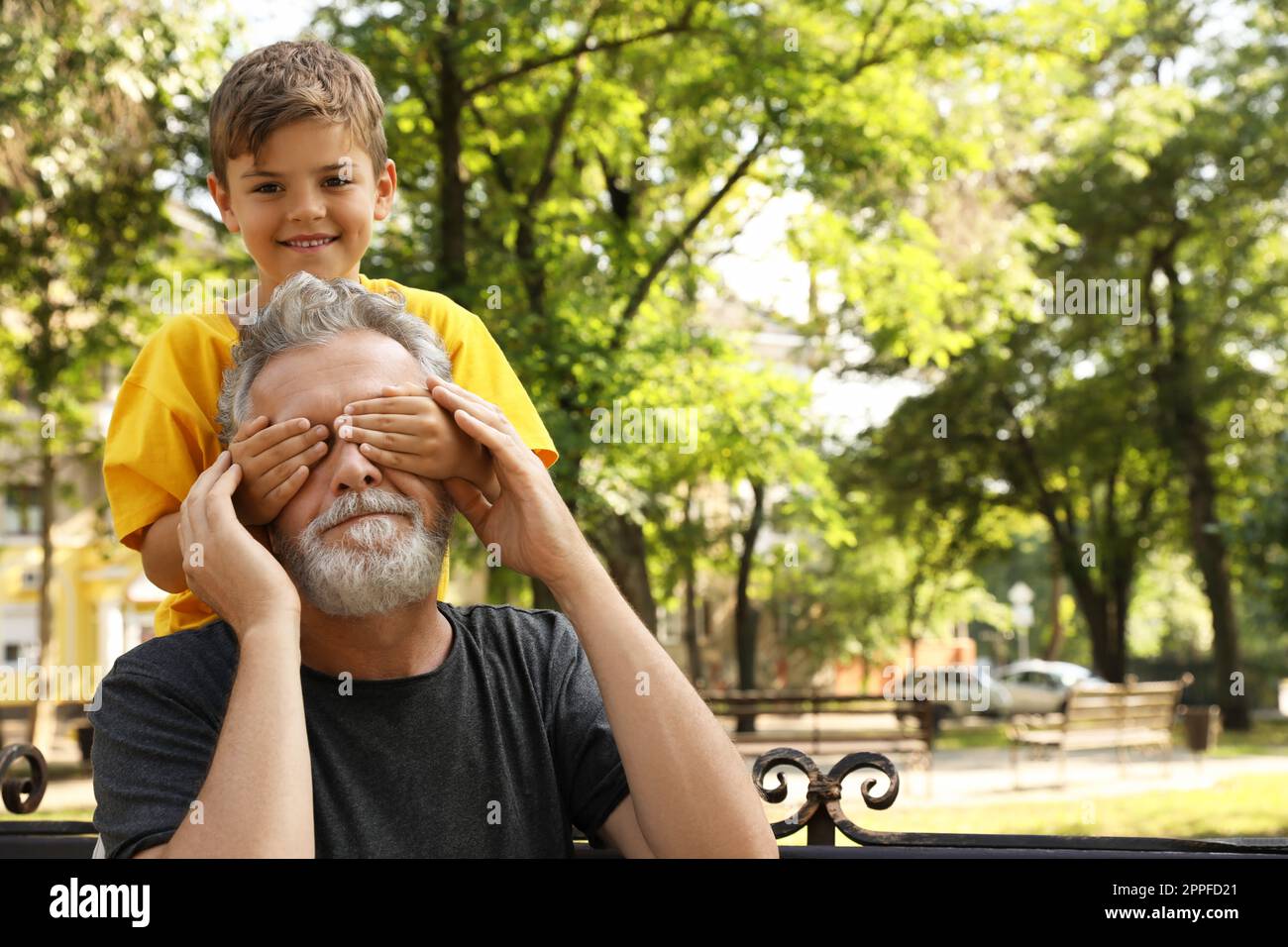 Senior man with his little grandson having fun together in park Stock ...