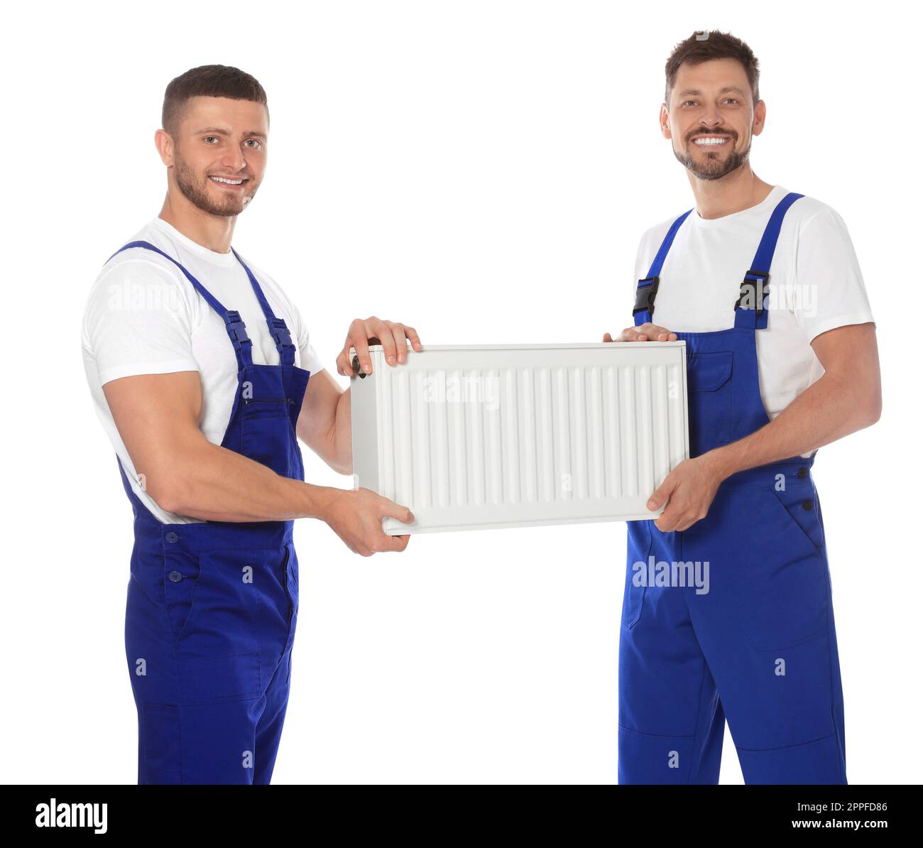 Professional plumbers with new heating radiator on white background ...