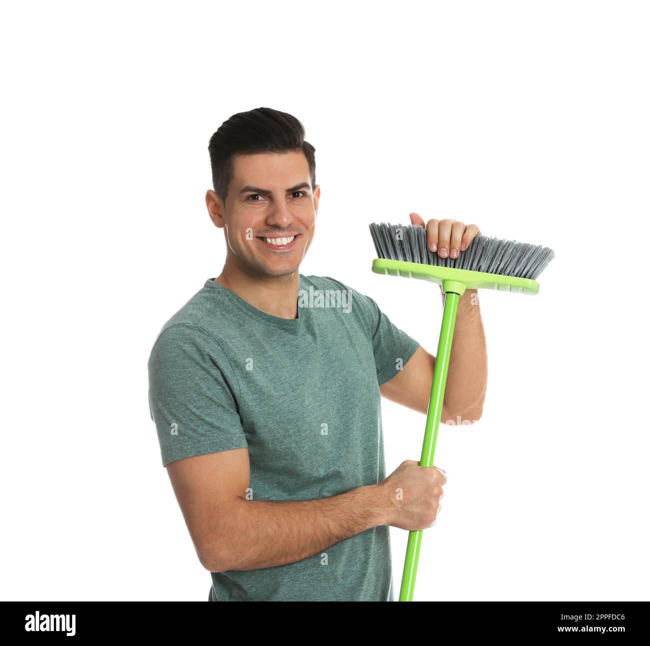 Man with green broom on white background Stock Photo - Alamy