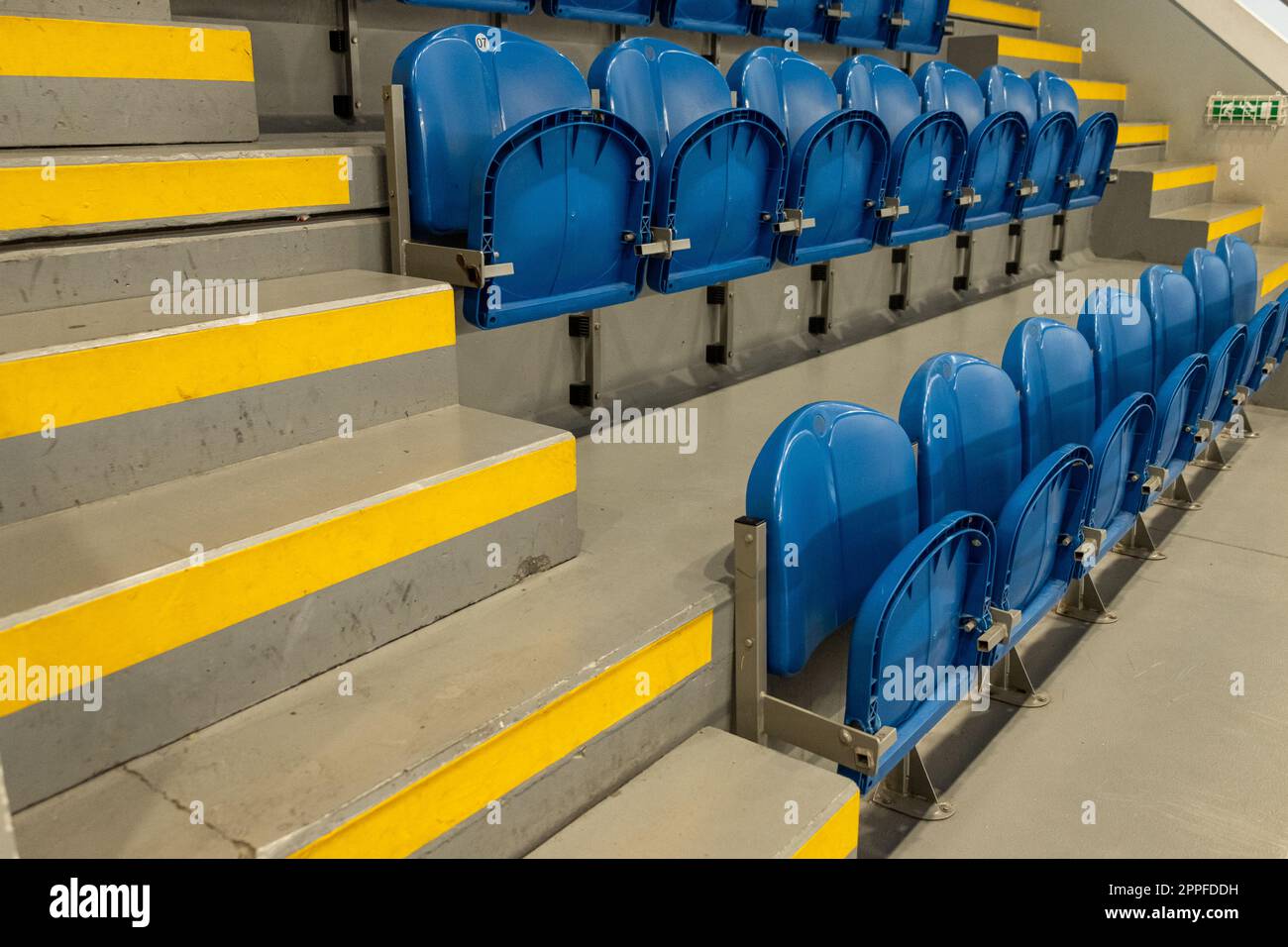 empty blue bleachers of a sports center building Stock Photo - Alamy
