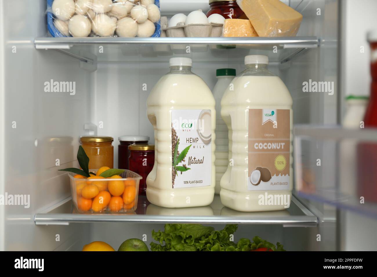 Gallons of hemp and coconut milk a in refrigerator. Vegan product Stock ...