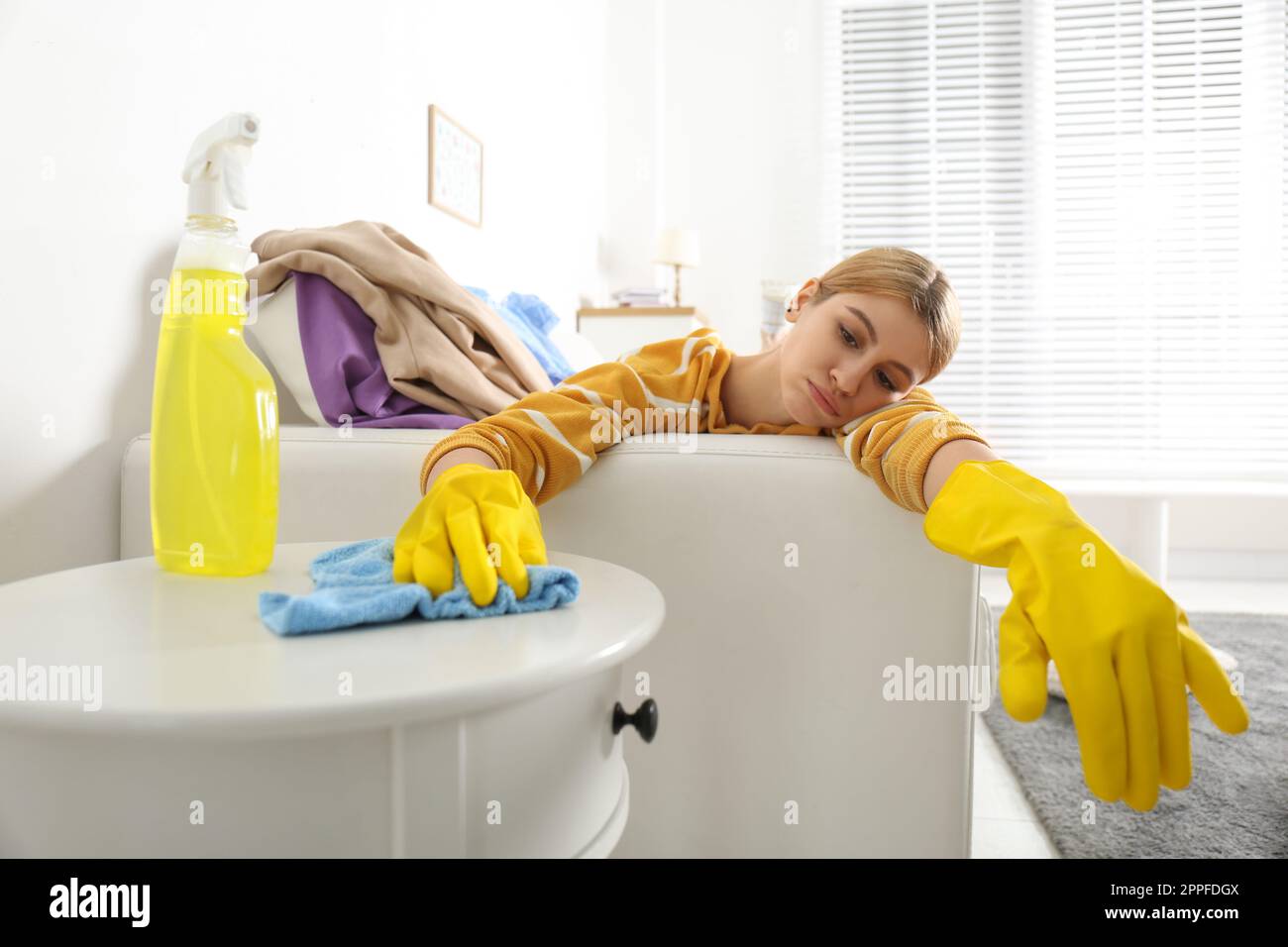 Lazy young woman wiping table at home. Cleaning and housework Stock ...