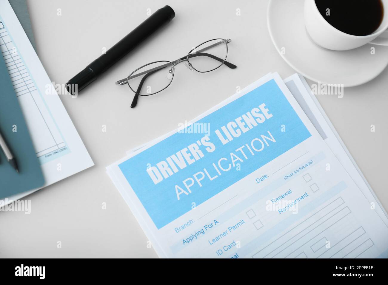 Driver's license application form, glasses and cup of coffee on white table, above view Stock ...
