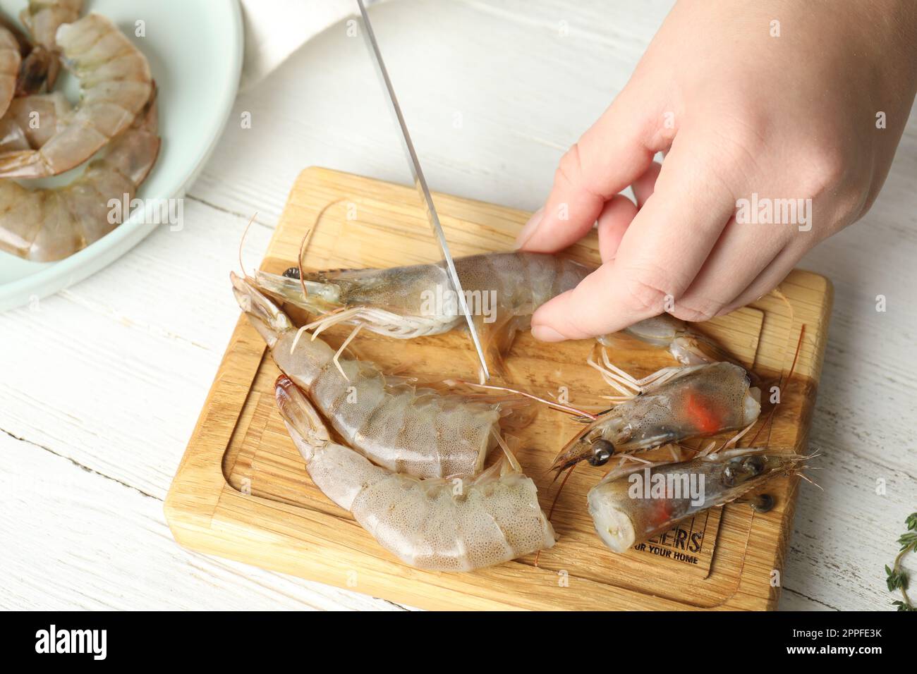 Woman cutting fresh shrimp hi-res stock photography and images - Alamy