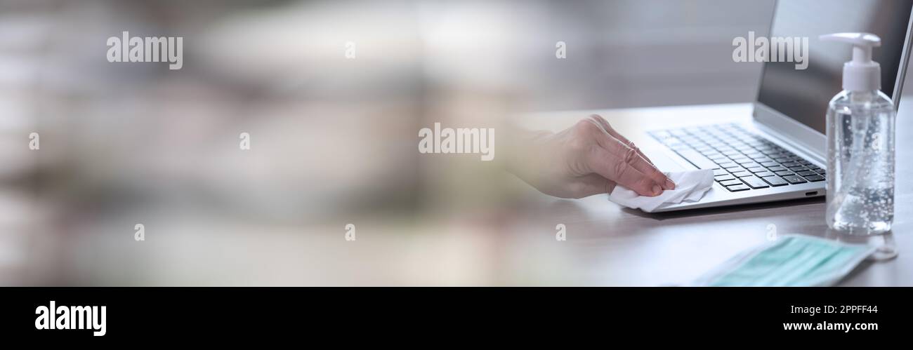 Woman disinfecting laptop keyboard with antibacterial wipe; prevention ...